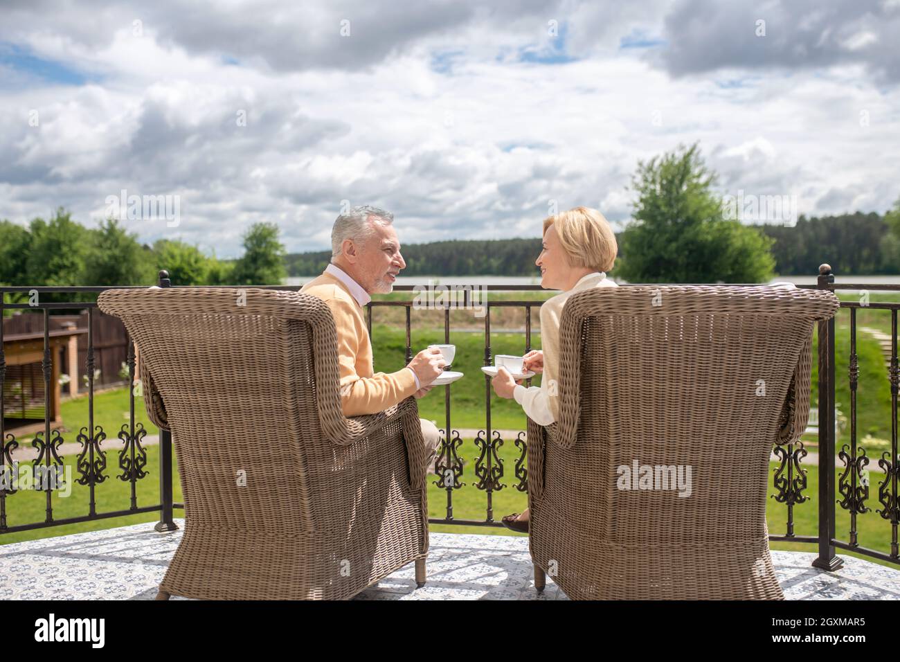 Two adult people drinking coffee on the terrace Stock Photo - Alamy