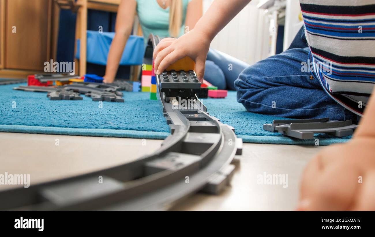 Closeup image of toy railroad with colorful train on floor at child's ...