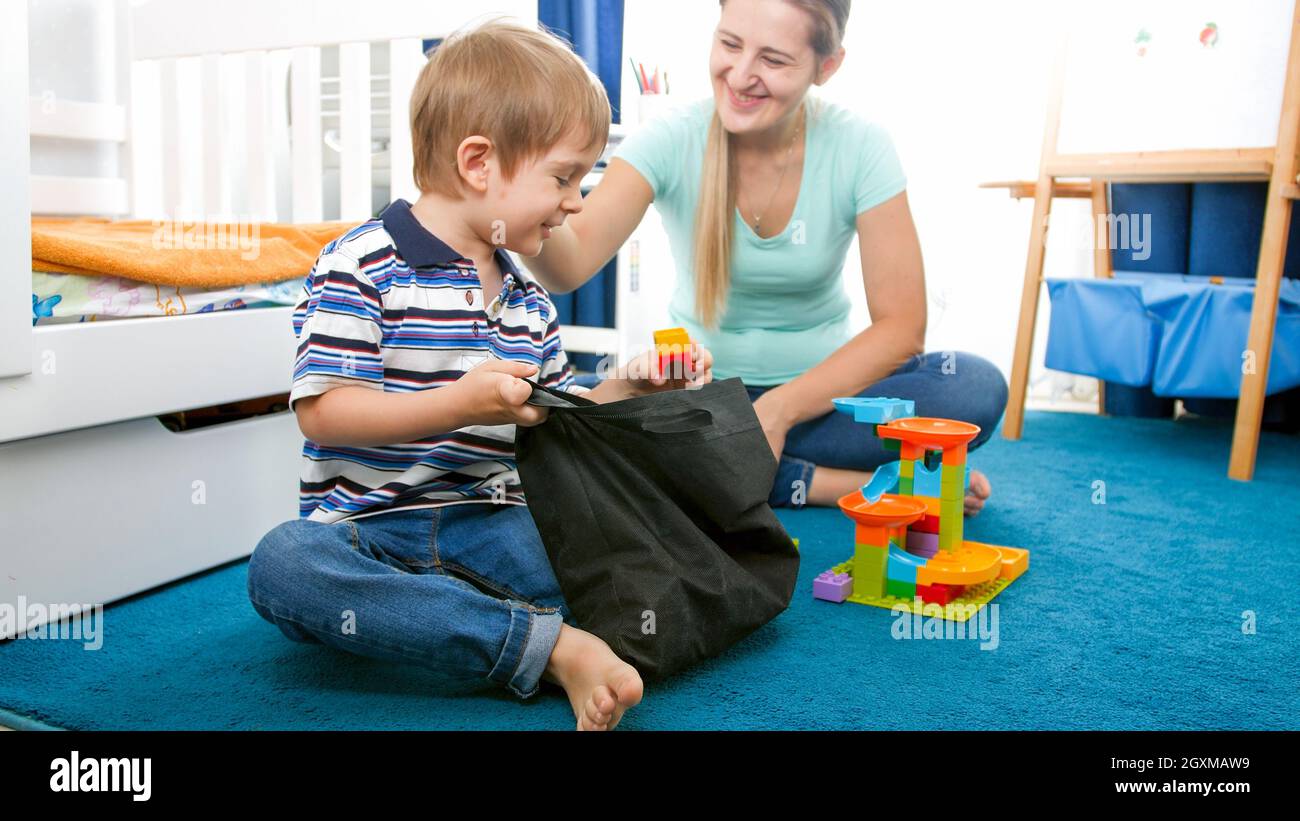 Child picking up toys hi-res stock photography and images - Alamy