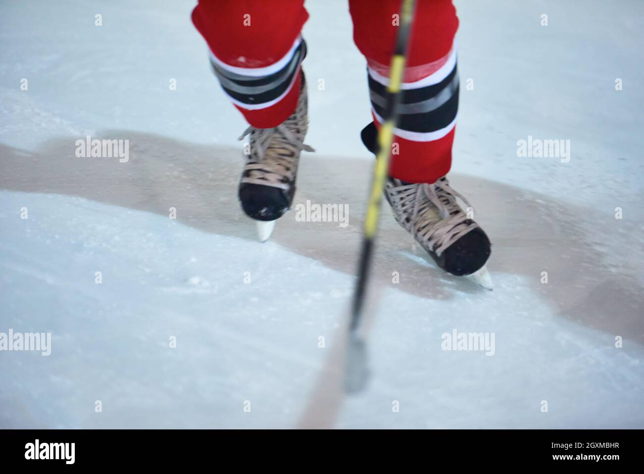 ice hockey player in action kicking with stick Stock Photo - Alamy