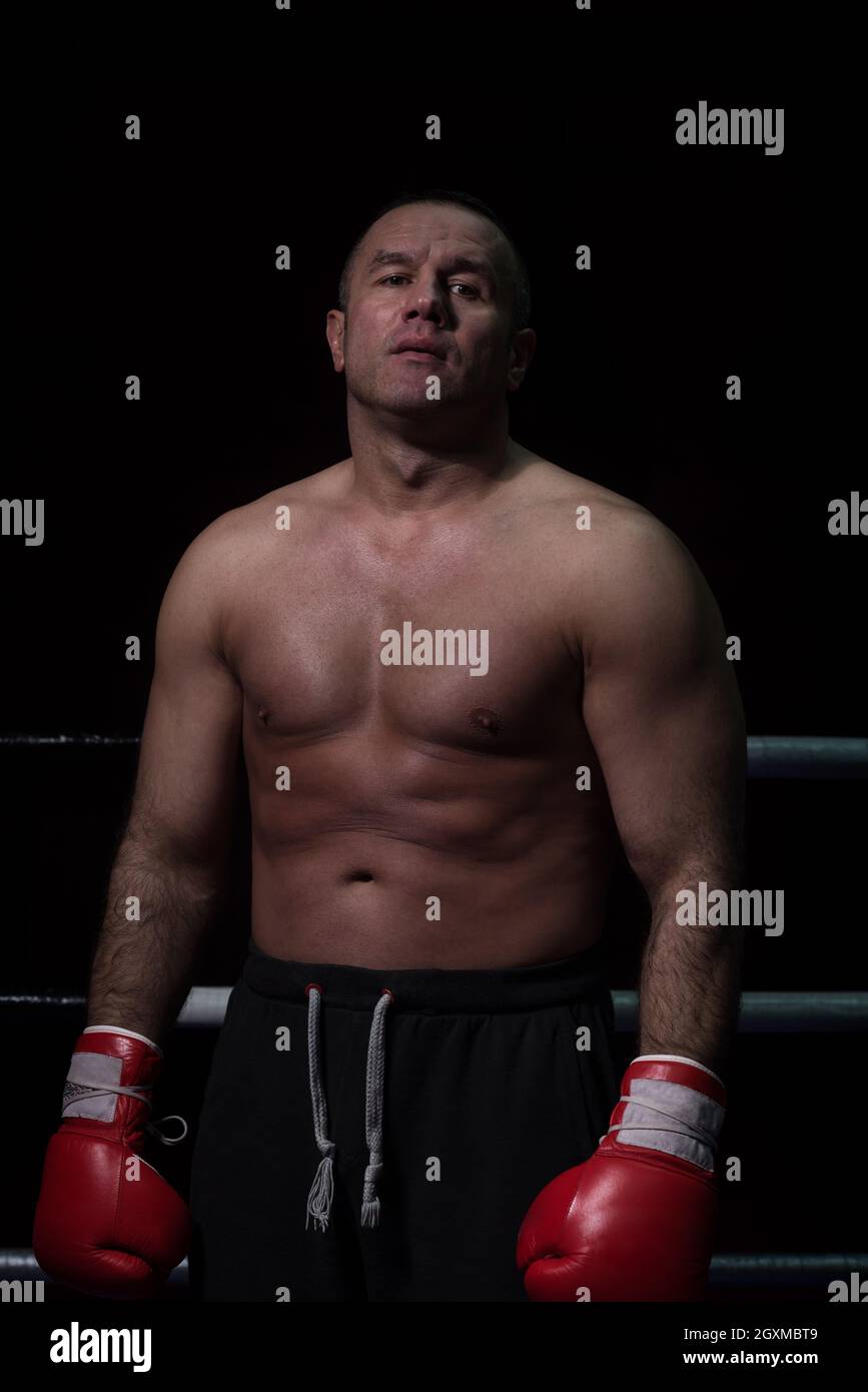 portrait of muscular professional kickboxer who standing in the ring ...