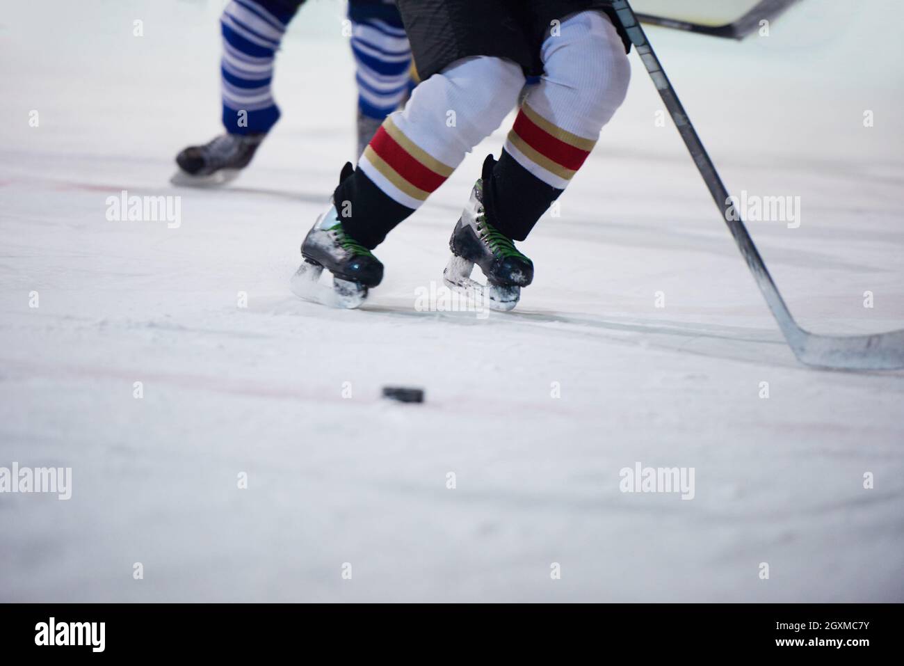 ice hockey player in action kicking with stick Stock Photo - Alamy