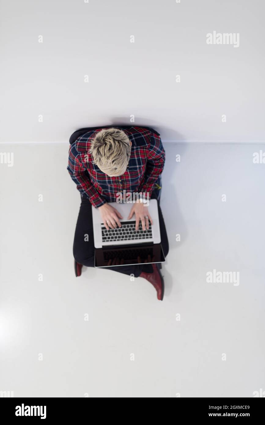 top view of young business woman working on laptop computer in modern ...