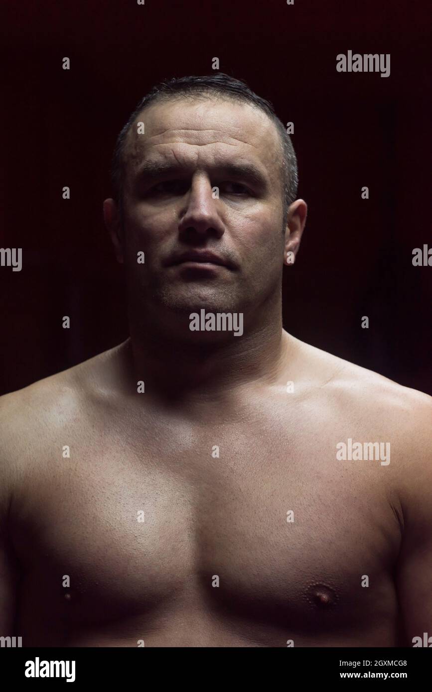 portrait of muscular professional kickboxer who standing in the ring ...