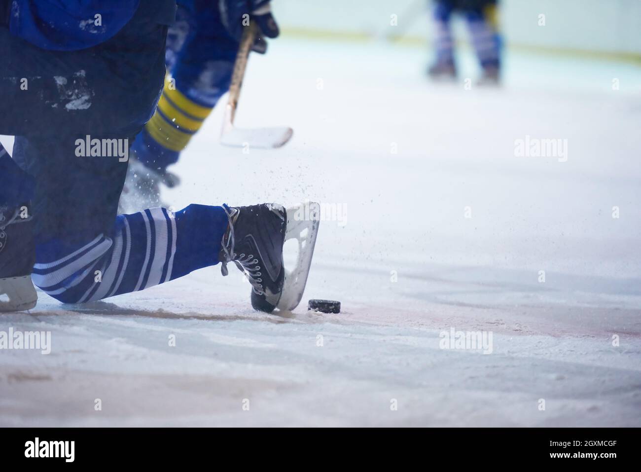 ice hockey player in action kicking with stick Stock Photo - Alamy