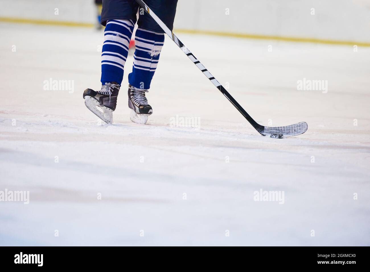 ice hockey player in action kicking with stick Stock Photo - Alamy