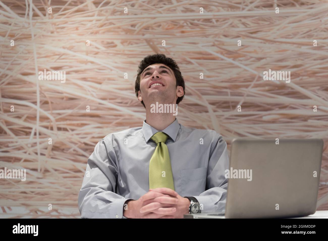 happy young business man working on laptop computer at his desk in ...