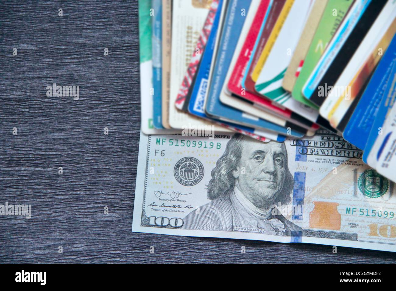 Hundred dollar notes and credit cards. Pile of credit cards in dollars ...