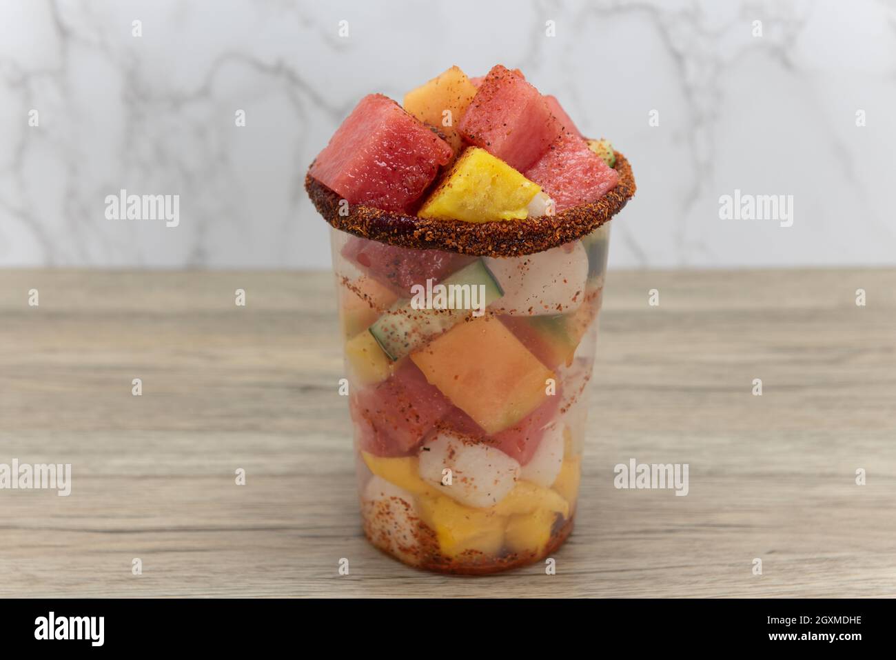 Chopped fruit fills this seasoned cup full of mango, watermelon, and ...
