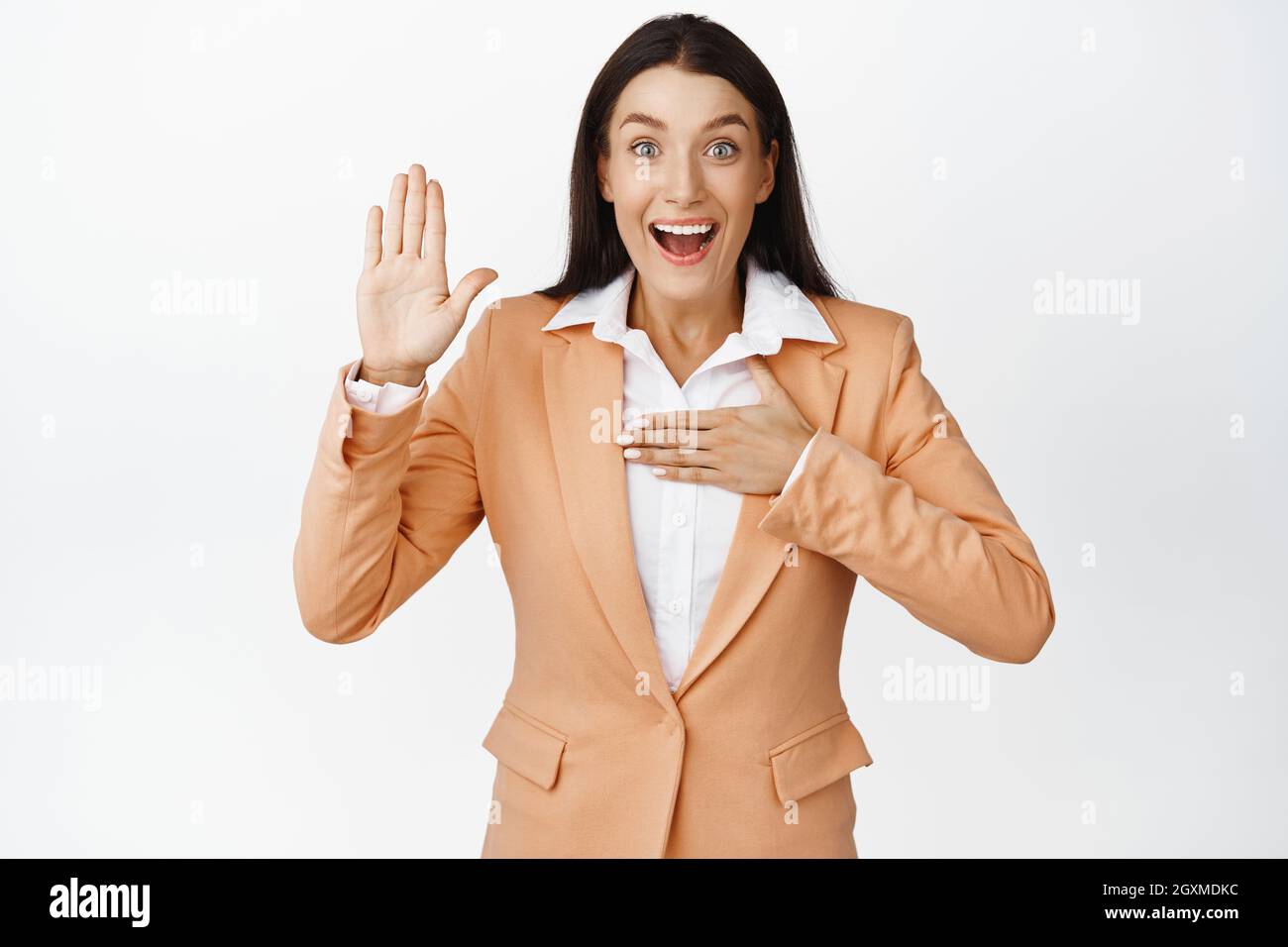 Excited corporate woman raising one hand and looking happy, making ...