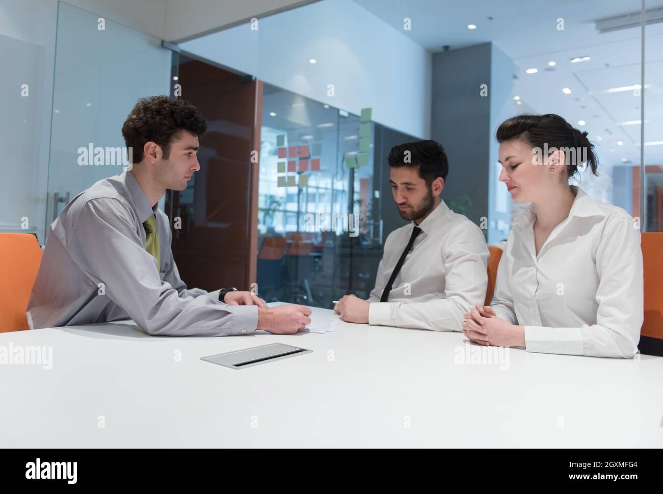 signing contract on partners back, young couple on business meeting ...