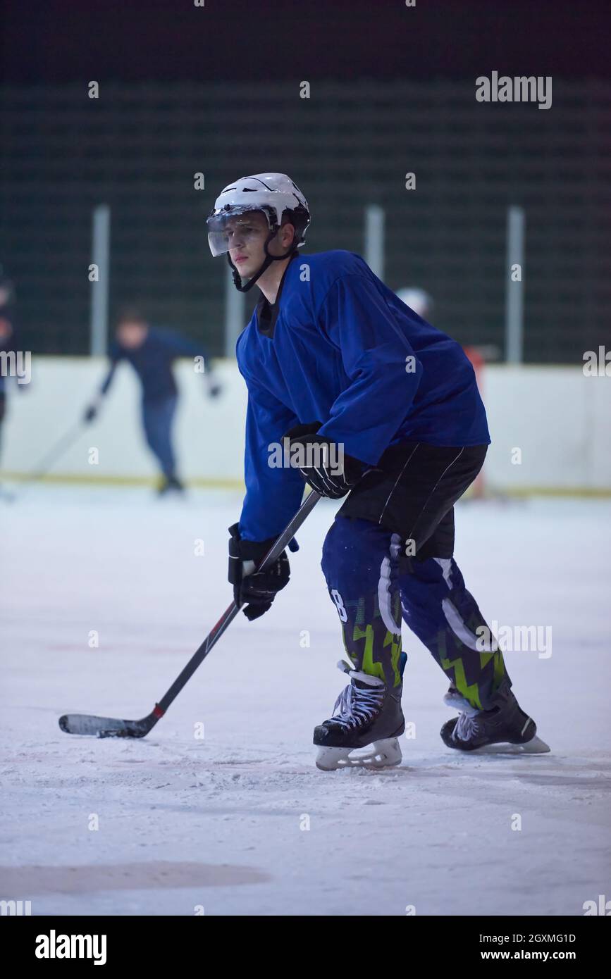 ice hockey player in action kicking with stick Stock Photo - Alamy