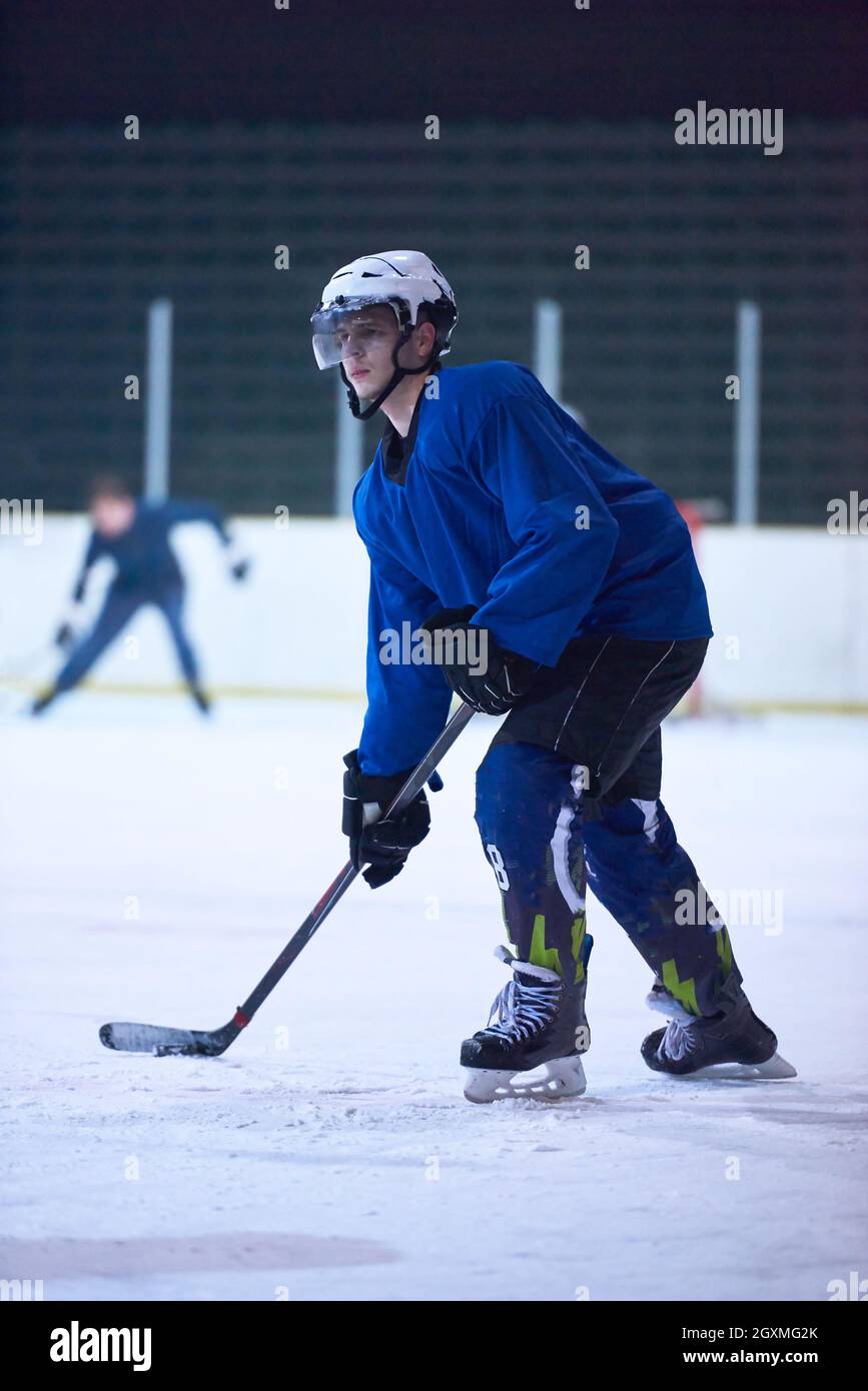 ice hockey player in action kicking with stick Stock Photo - Alamy