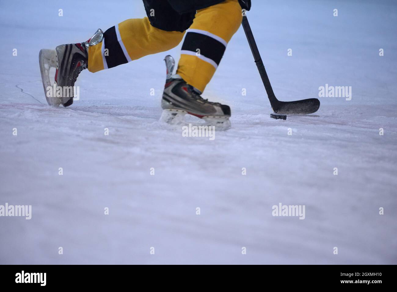 ice hockey player in action kicking with stick Stock Photo - Alamy