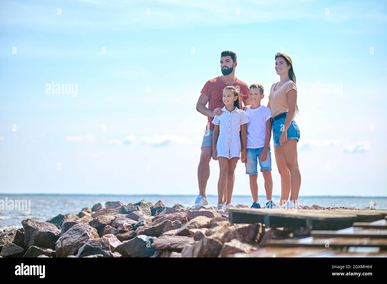 A family spending time on a beach and feeling awesome Stock Photo - Alamy