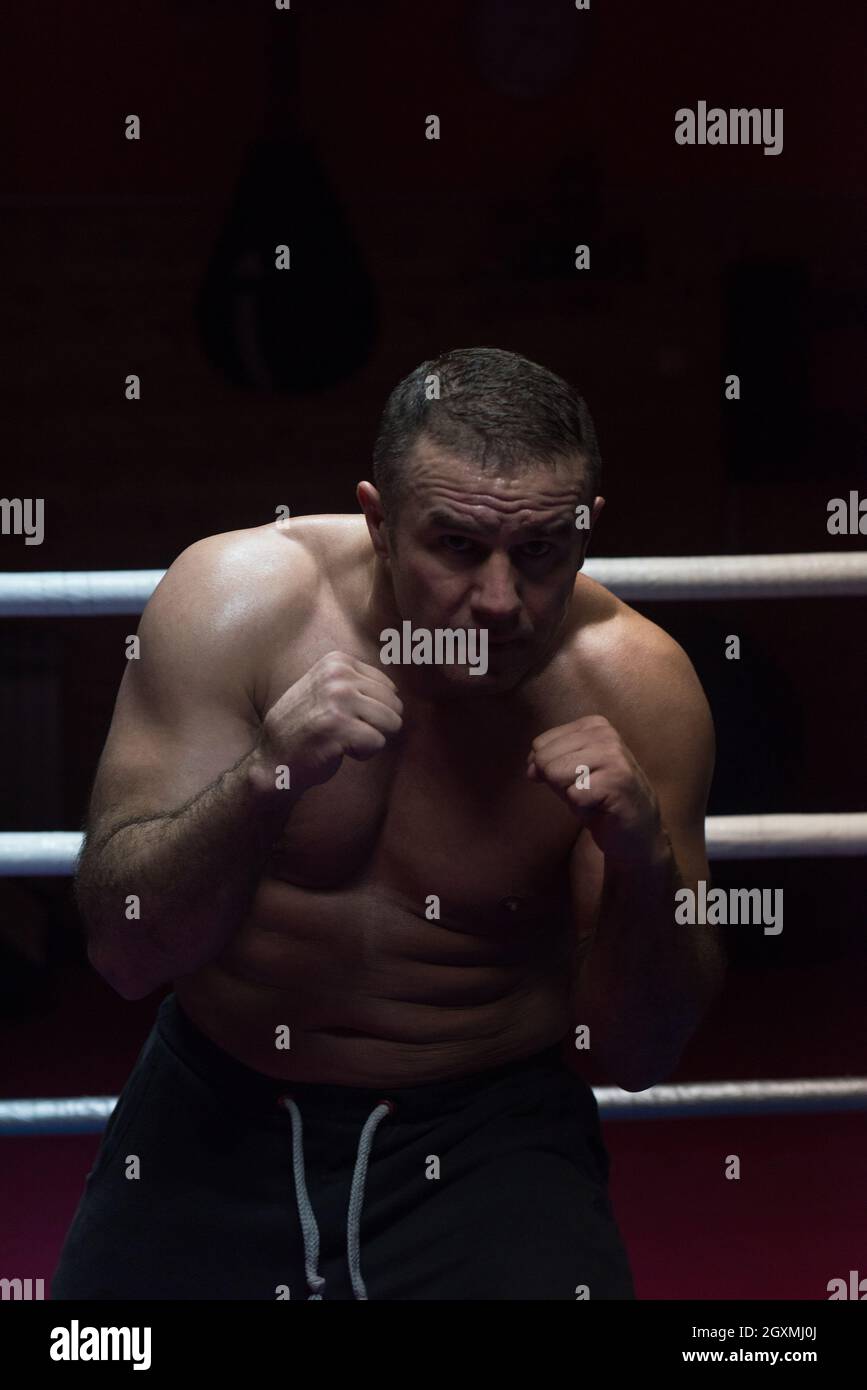 professional kickboxer with hands in martial arts position training for ...
