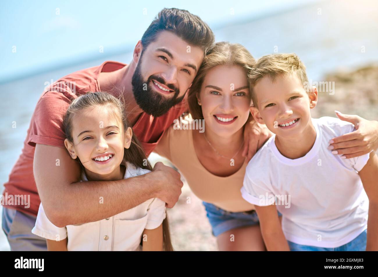 A picture of happy smiling family having fun on a beach Stock Photo - Alamy