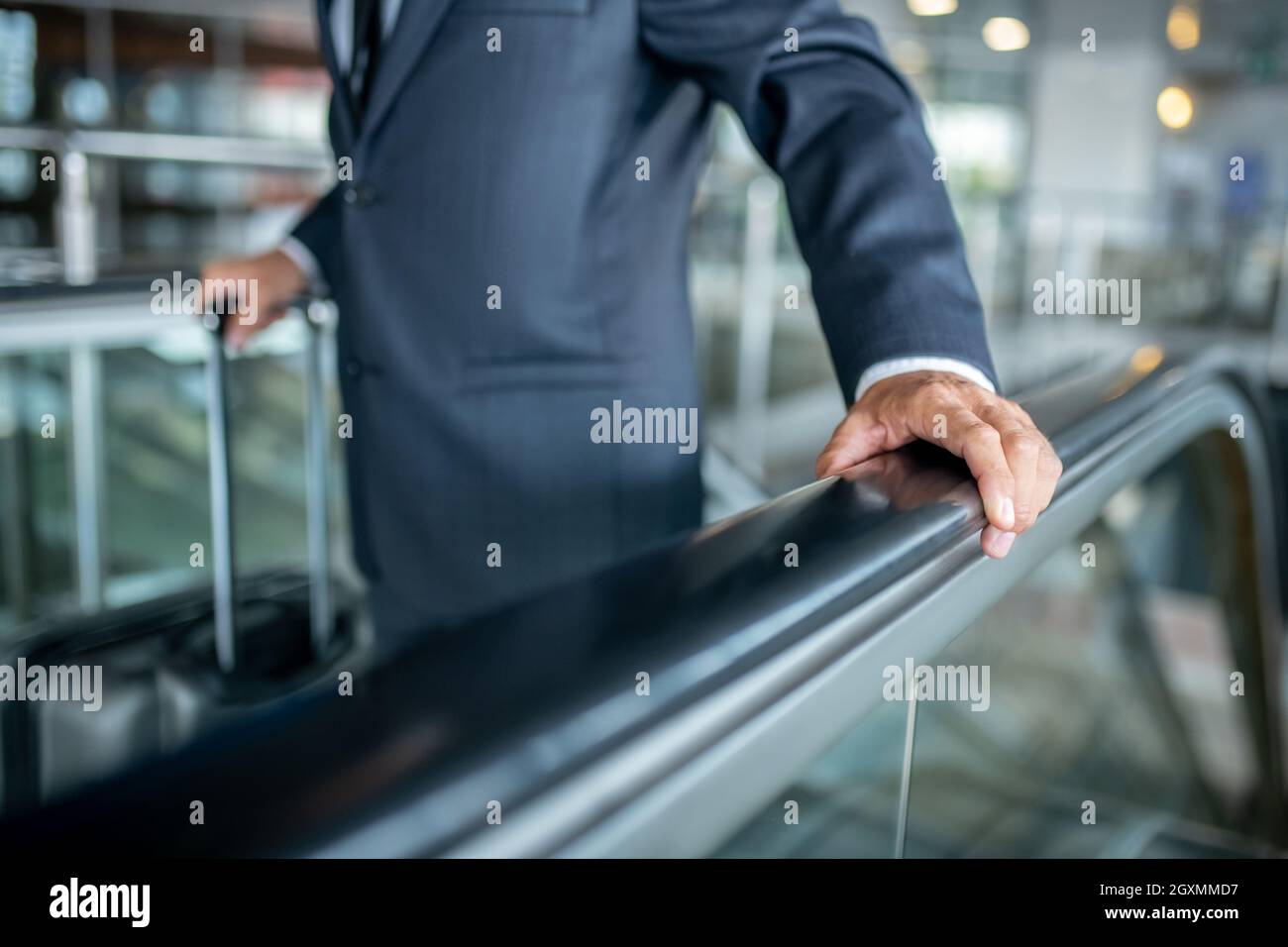 Man hand holding escalator handrail hi-res stock photography and images ...