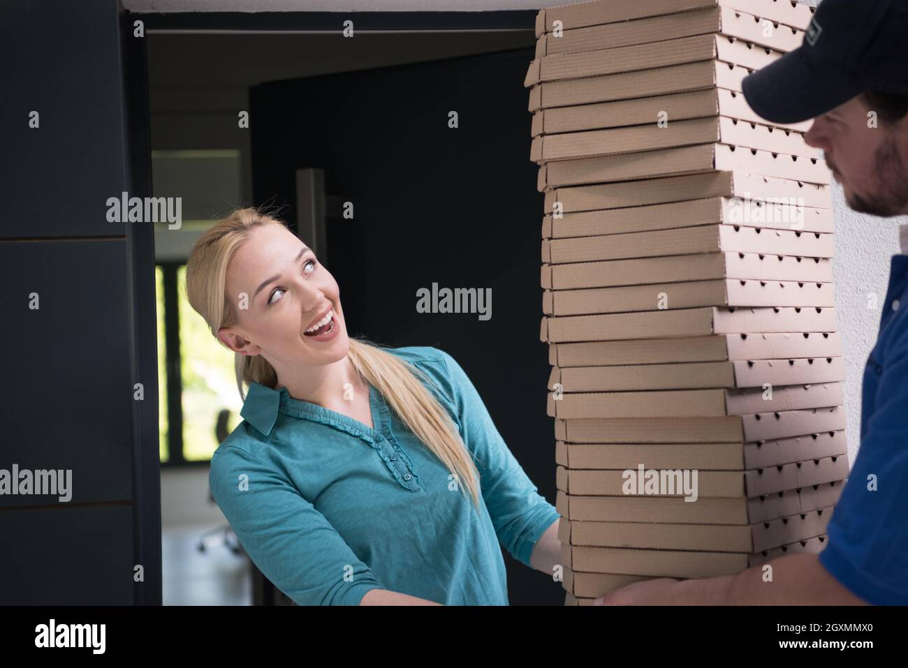 Pizza Delivery Man Giving Pizza Boxes To Smiling Young Woman Stock ...