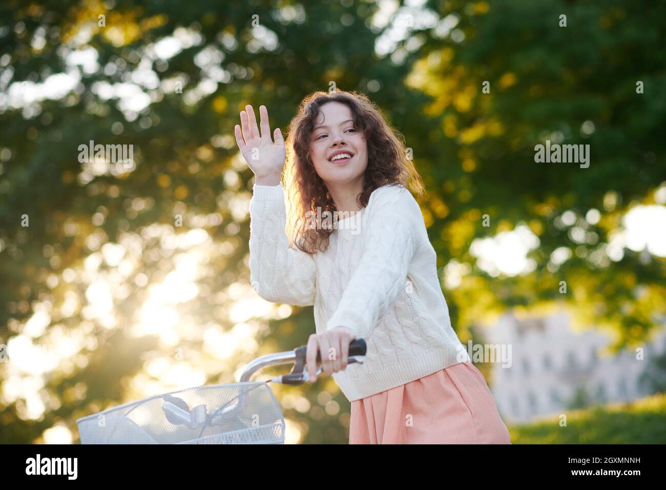 Cute young girl in the park looking dreamy Stock Photo - Alamy