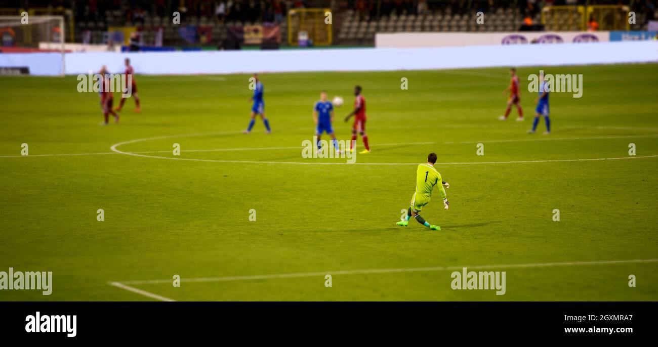 Soccer goalkeeper kicks out the ball during the match at stadium Stock ...