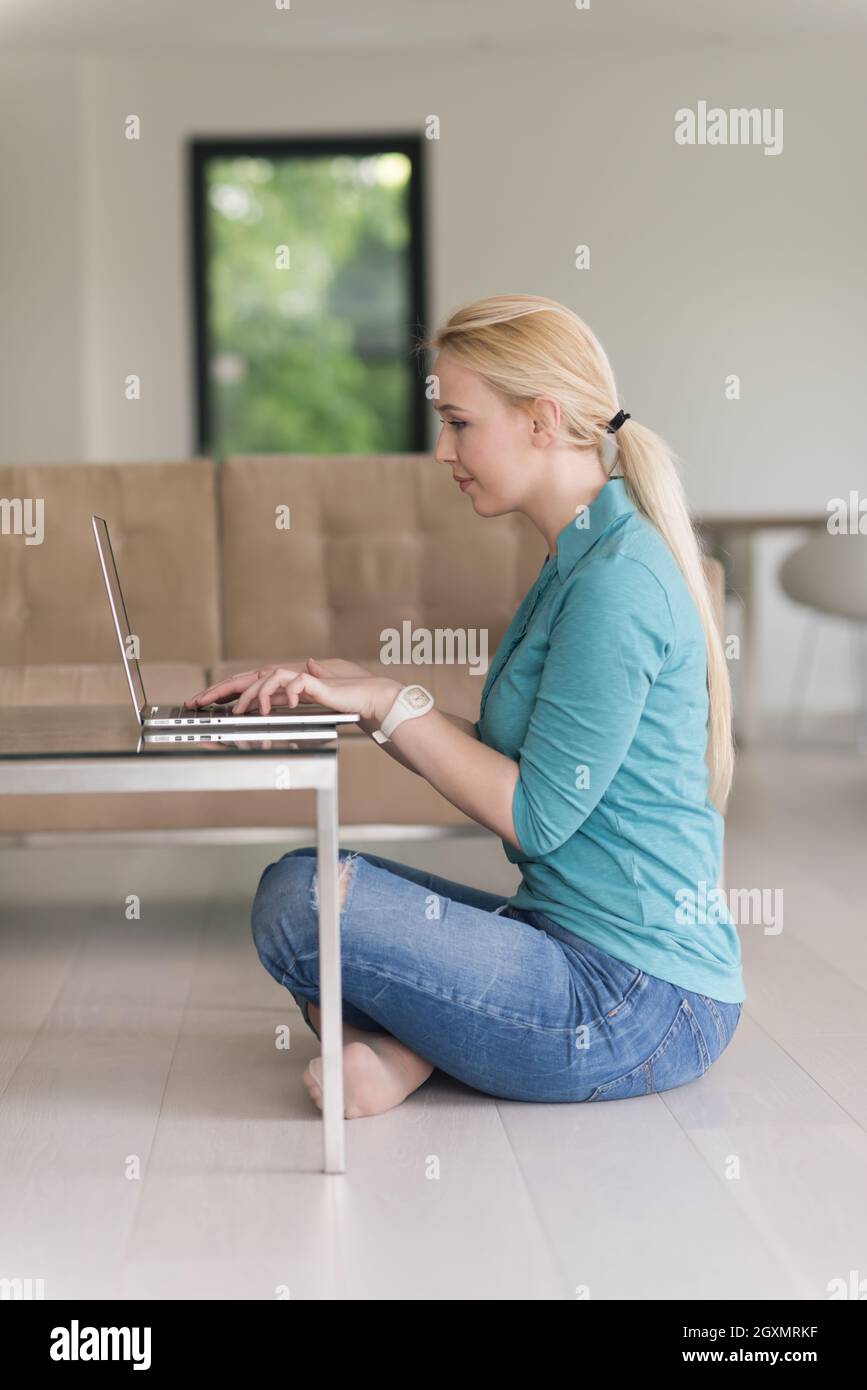 beautiful young women using laptop computer on the floor of her luxury ...