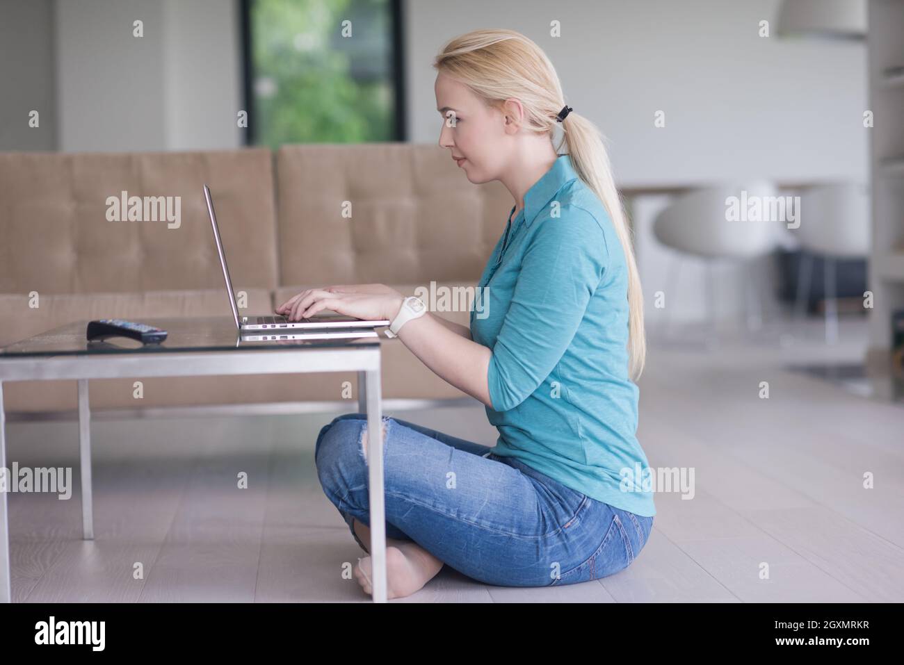 beautiful young women using laptop computer on the floor of her luxury ...
