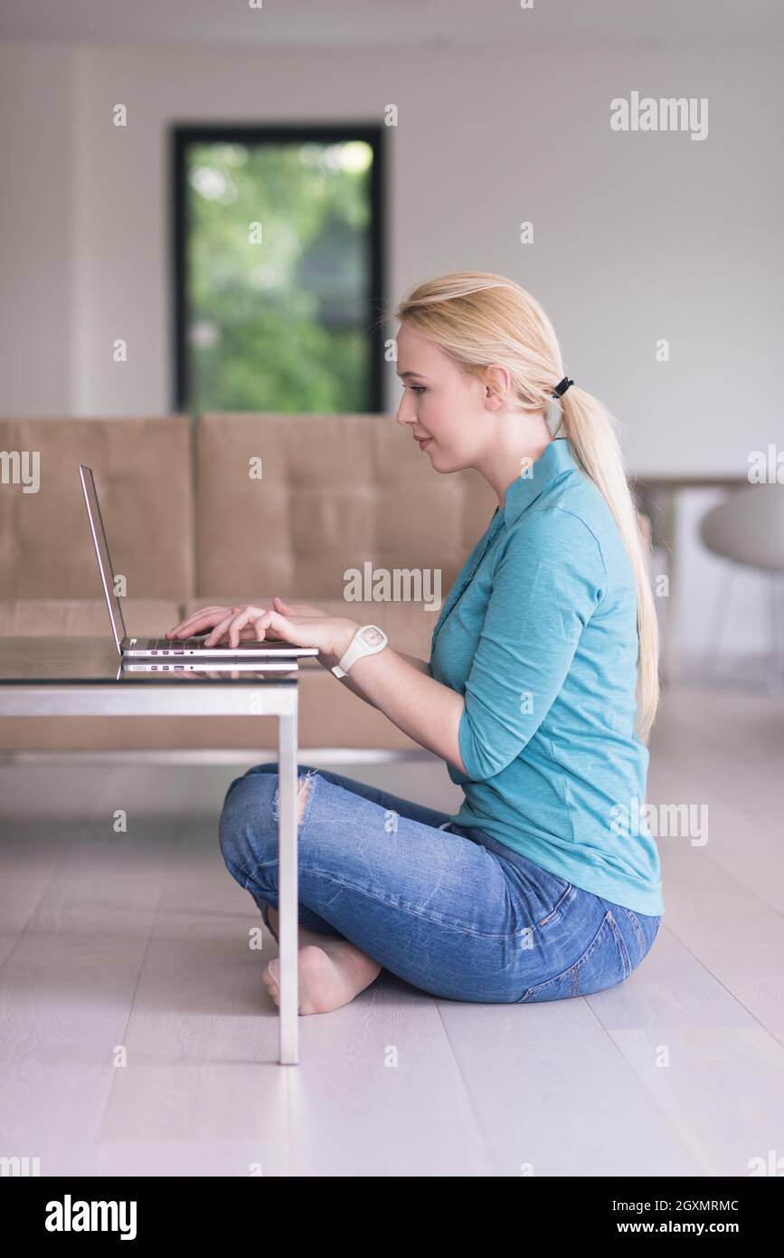 beautiful young women using laptop computer on the floor of her luxury ...