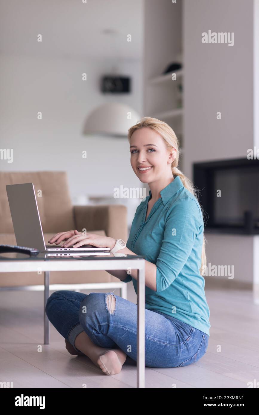 beautiful young women using laptop computer on the floor of her luxury ...