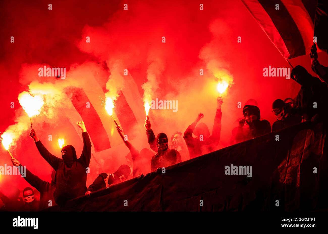 Football Hooligans With Mask Holding Torches In Fire While Supporting