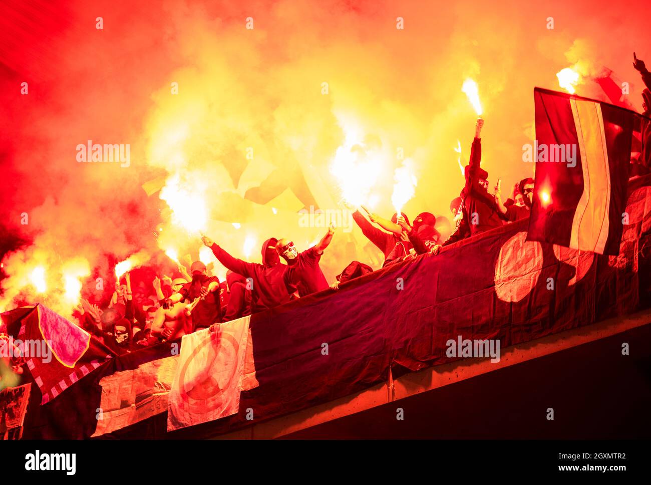 Football Hooligans With Mask Holding Torches In Fire While Supporting