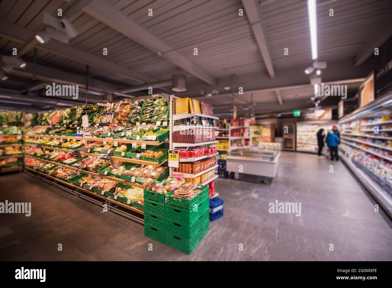 group of people shopping in modern supermarket and checking prices and ...