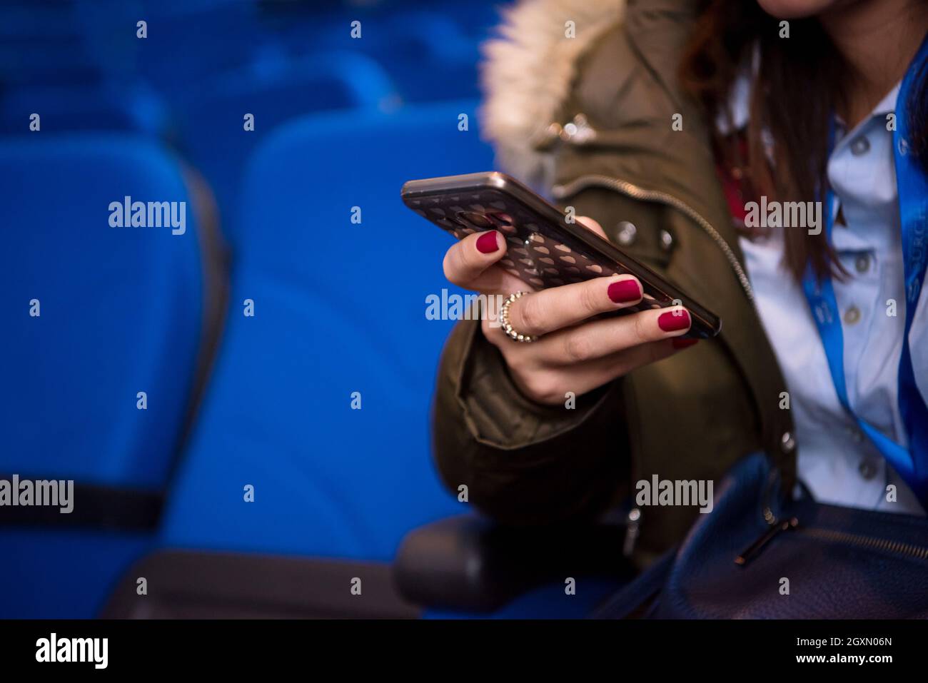 casual business woman hand with red nails typing on smart phone during ...