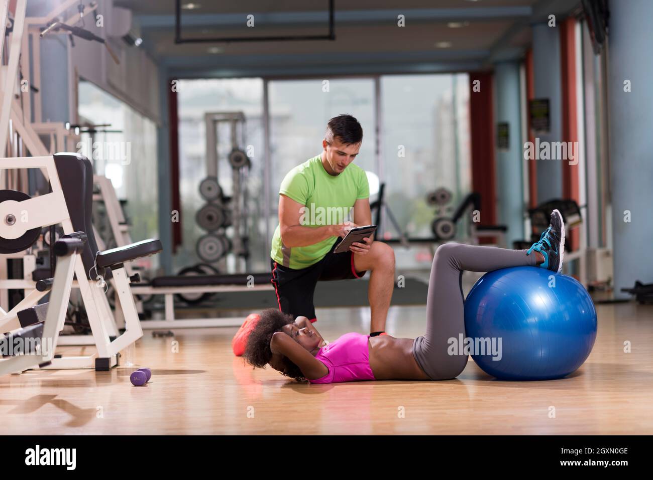 healthy young couple exercise in gym pilates workout with personal ...