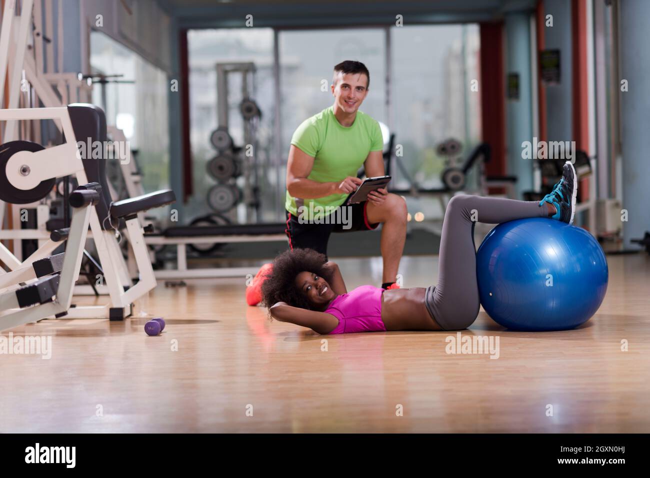 healthy young couple exercise in gym pilates workout with personal ...