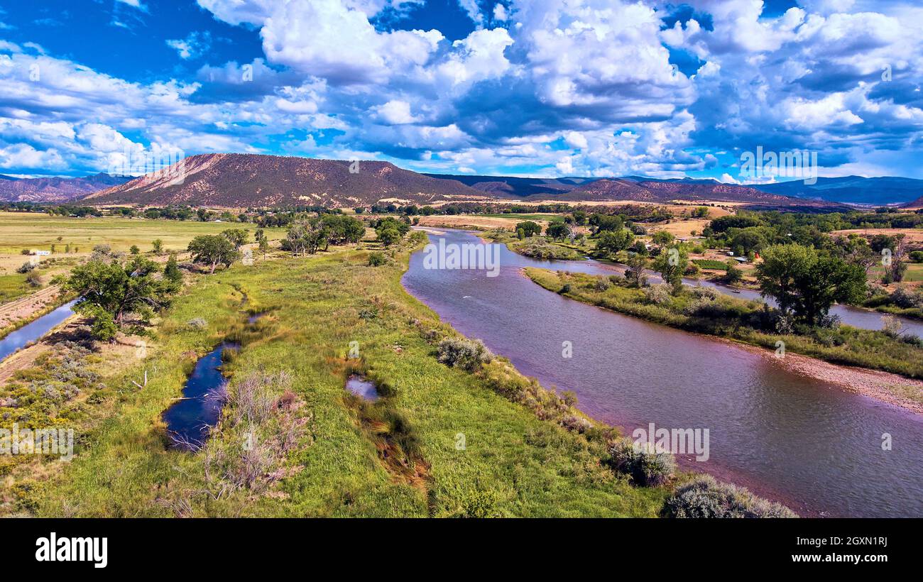 View of river in desert with mountains in distance Stock Photo - Alamy