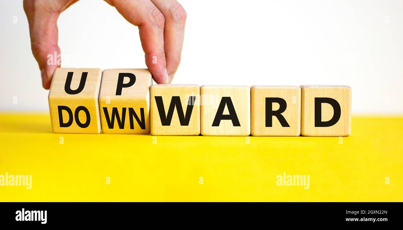Upward or downward symbol. Businessman turns wooden cubes and changes ...