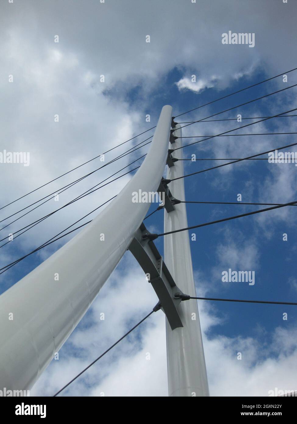 Worm's eye view of a white triangular bridge with suspension cables ...