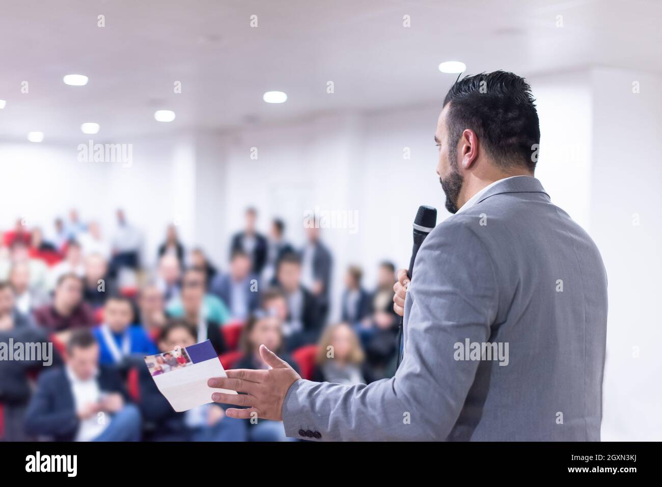 young businessman at business conference room with public giving ...