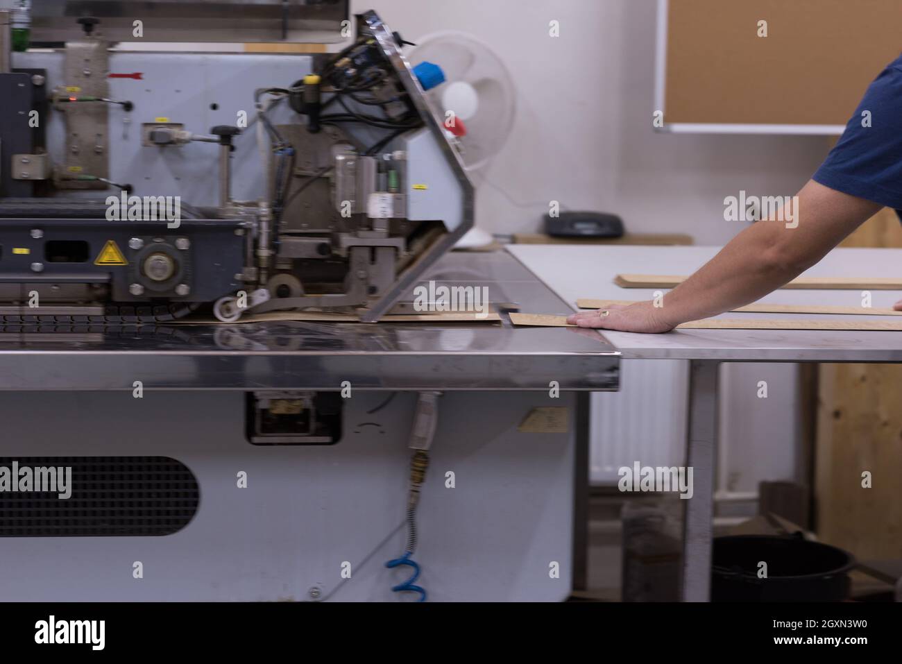 young positive engineer in front of furniture manufacture production at ...