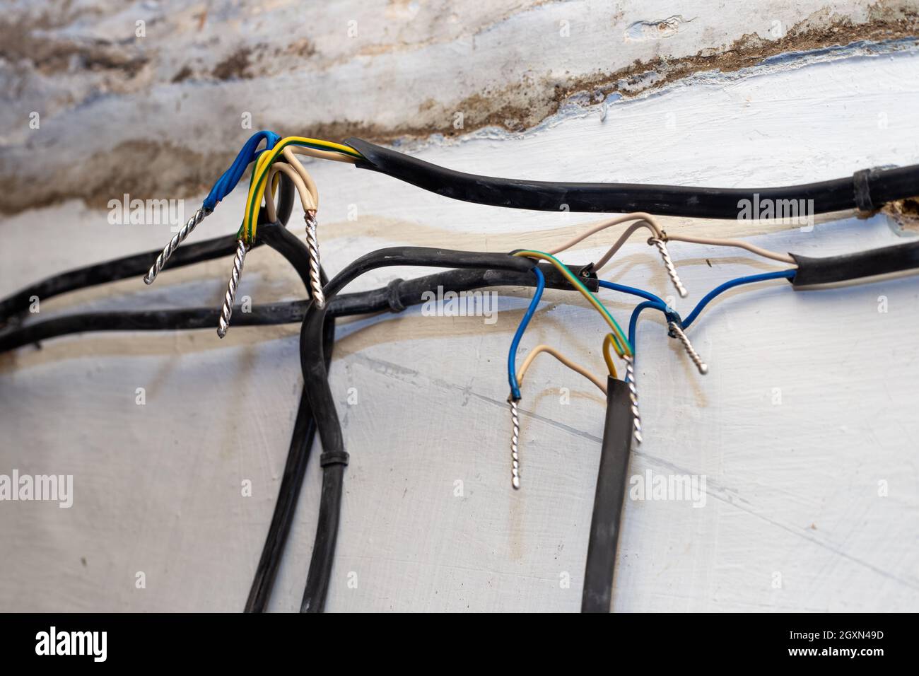 Connection of wires against the background of a wall in a house under ...