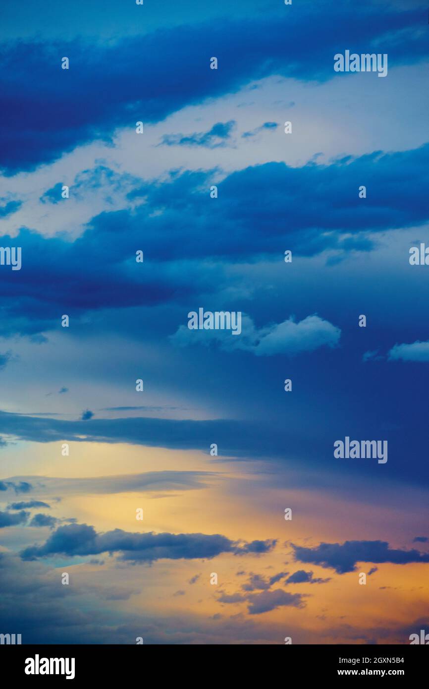Vertical clouds sunset sunrise with blue and gold color Stock Photo - Alamy