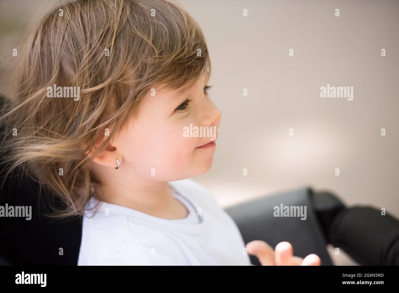 little and very beautiful baby girl sitting in the pram and waiting for ...