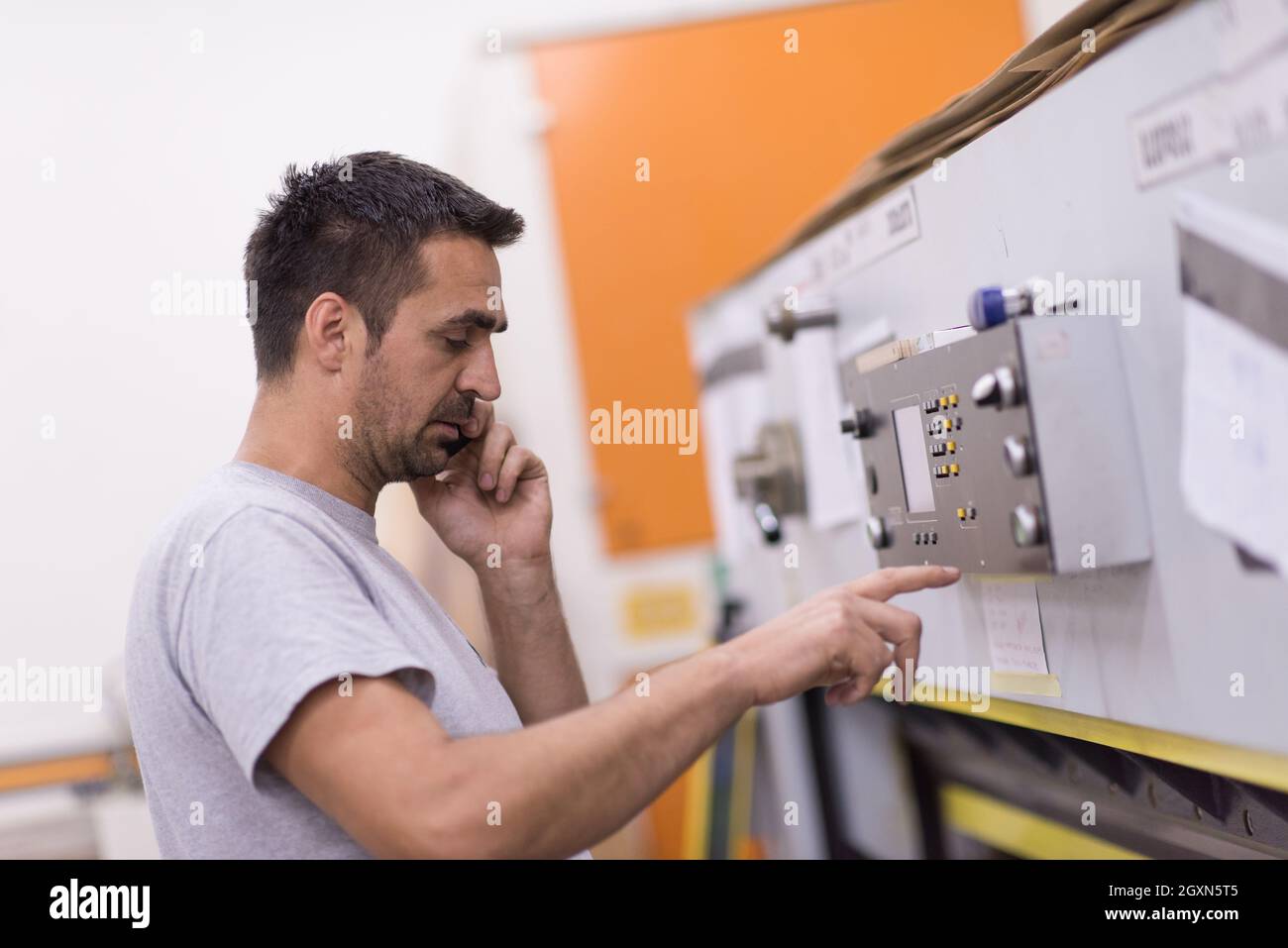 young positive engineer in front of furniture manufacture production at ...