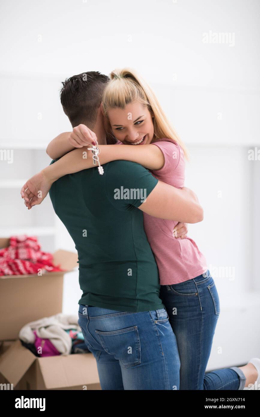 excited happy young couple looking forward to moving into a new home ...