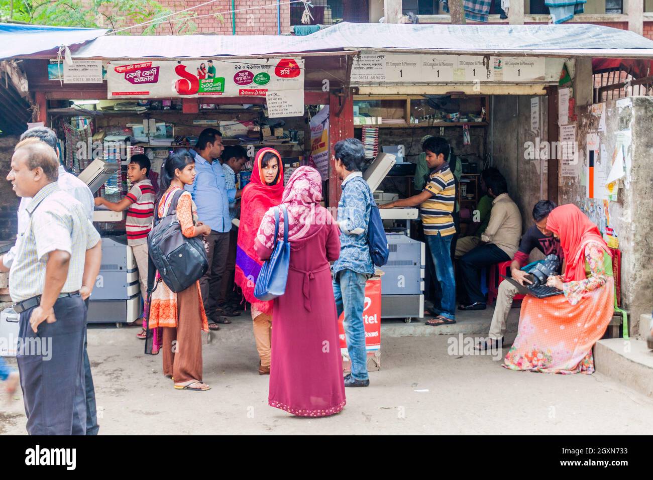 DHAKA, BANGLADESH - NOVEMBER 20, 2016: Customers at a copy shop in ...