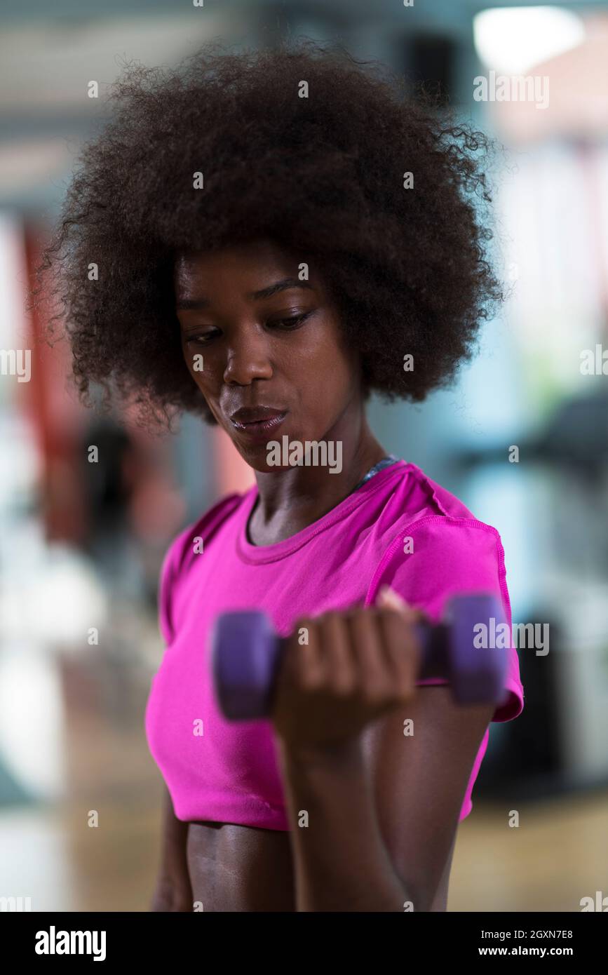 happy healthy african american woman working out in a crossfit gym on ...