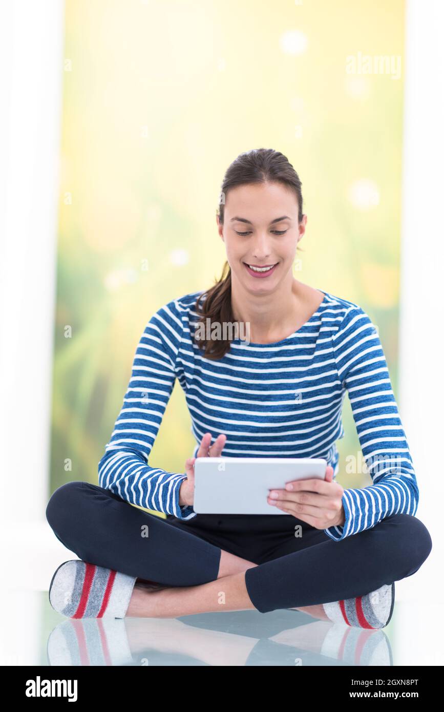 beautiful young women using tablet computer on the floor at home Stock ...