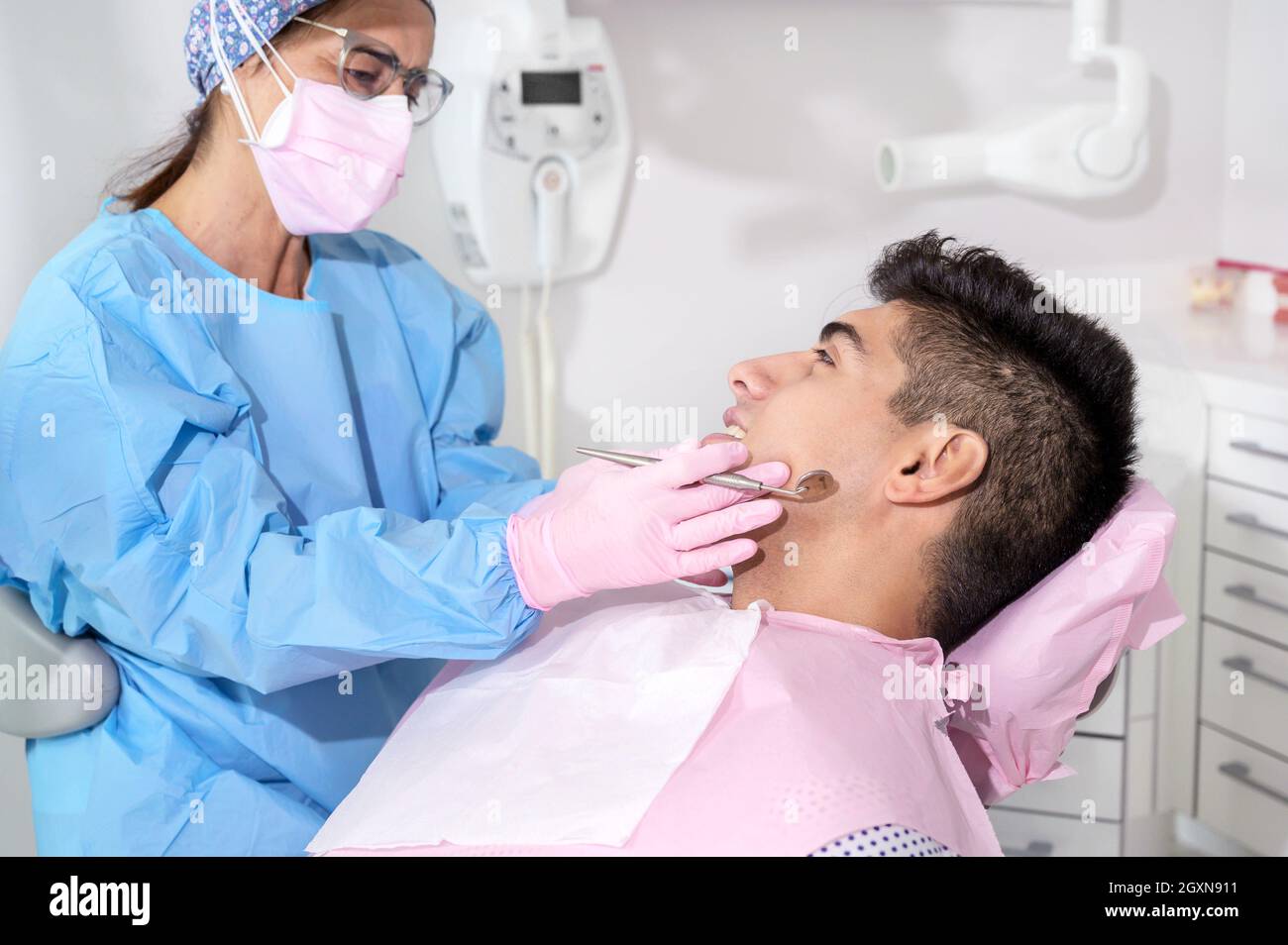 Doctor treats patient teeth in modern dental clinic. High quality photo ...