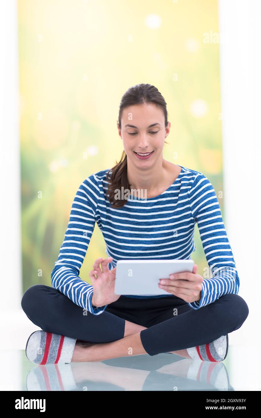 beautiful young women using tablet computer on the floor at home Stock ...